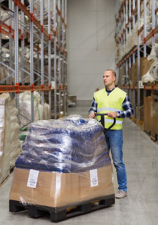 Man Carrying Loader with Goods at Warehouse Stock Photo - Image of ...