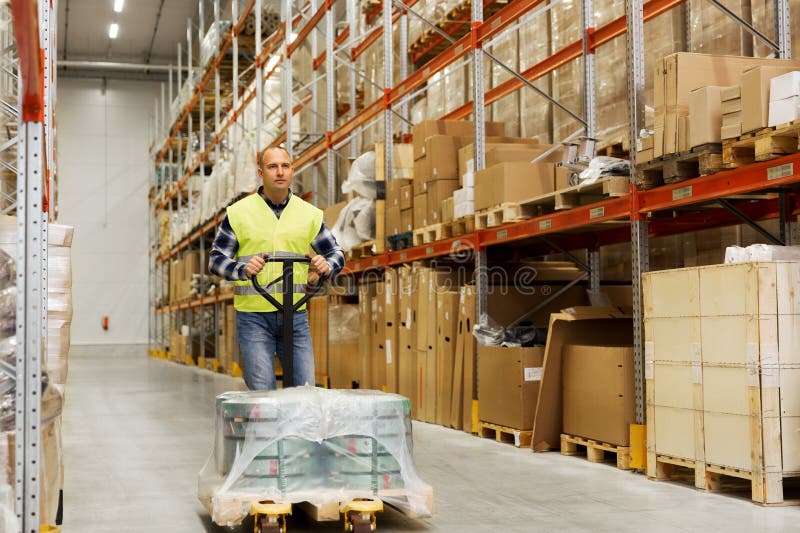 Man Carrying Loader with Goods at Warehouse Stock Photo - Image of ...