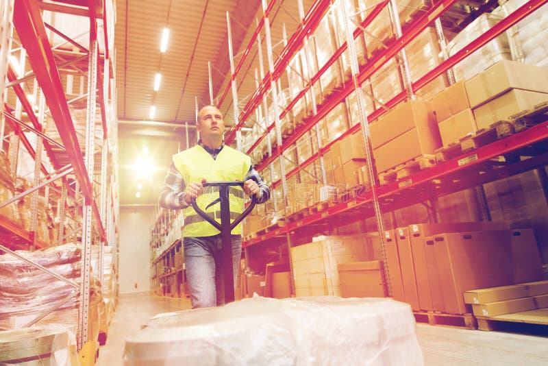 Man Carrying Loader with Goods at Warehouse Stock Photo - Image of ...