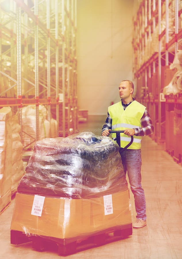 Man Carrying Loader with Goods at Warehouse Stock Photo - Image of pile ...