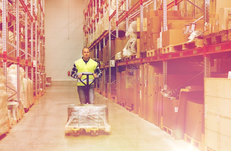 Man Carrying Loader with Goods at Warehouse Stock Image - Image of ...