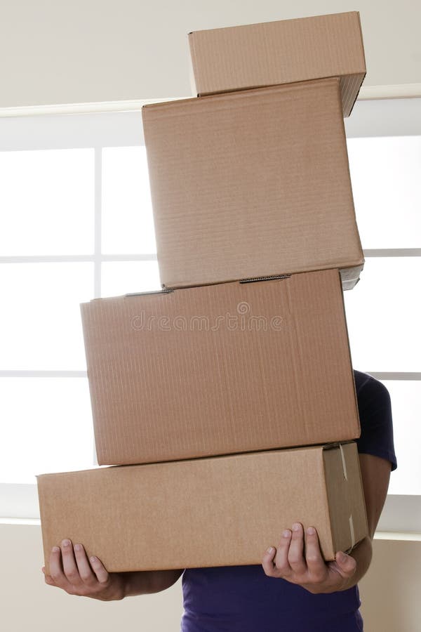 Man Carrying Stacked Boxes stock image. Image of brown - 17245509