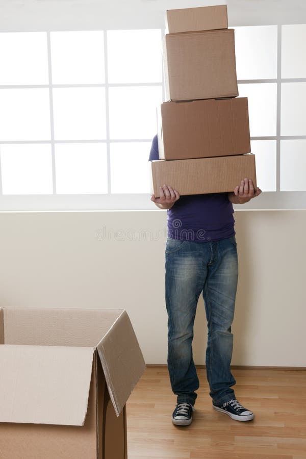 Man Carrying Stacked Boxes stock photo. Image of interior - 17245534