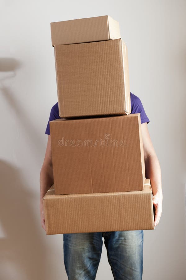 Man Carrying Stacked Boxes stock image. Image of carrying - 17245651