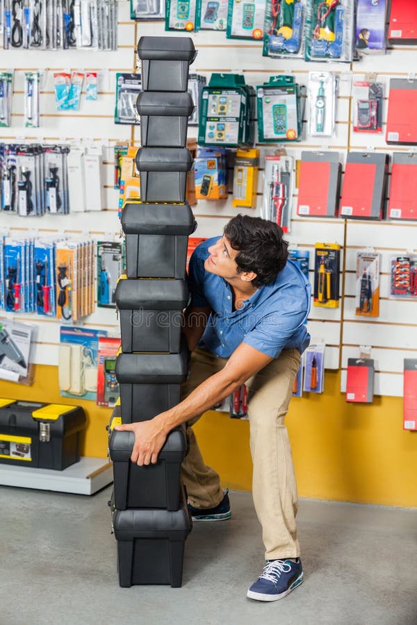 Man Carrying Toolbox on Shoulder in Hardware Store Stock Photo - Image ...