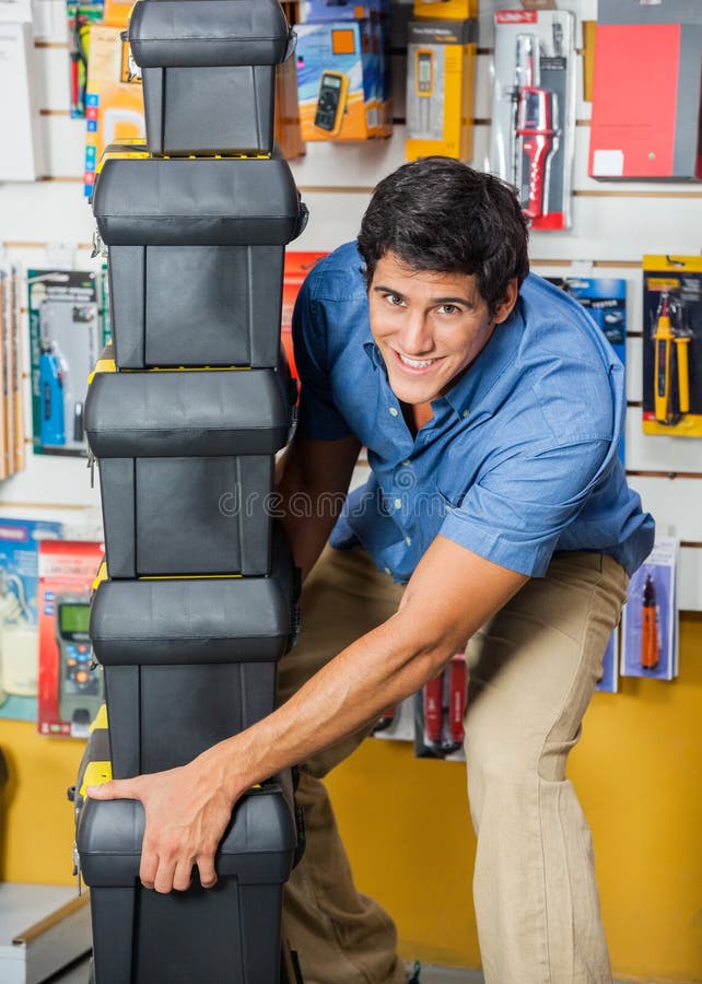 Man Carrying Toolbox on Shoulder in Hardware Store Stock Photo - Image ...