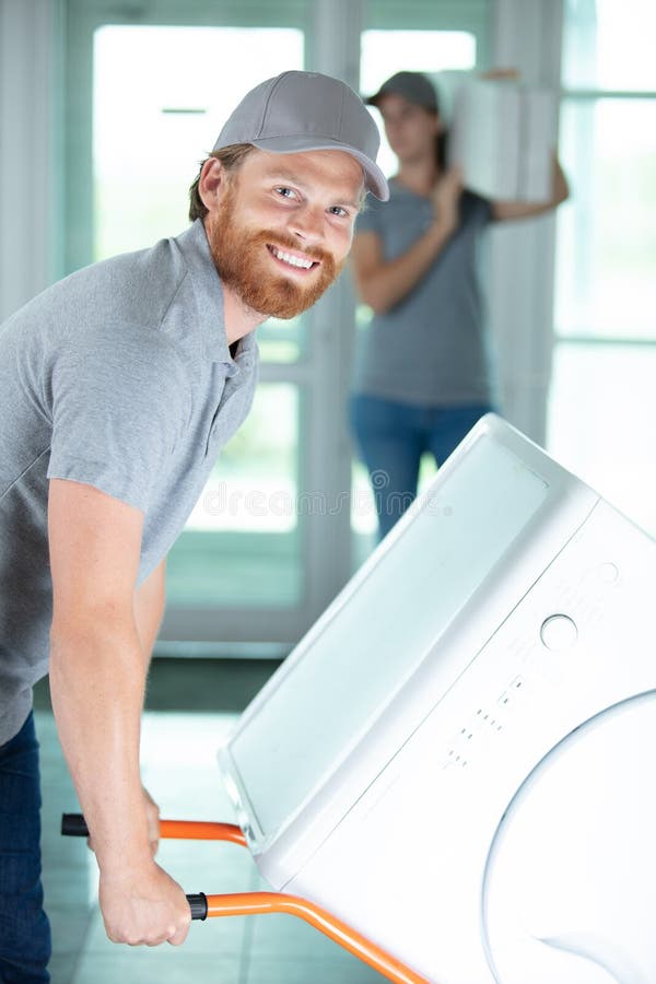 Man Carrying Washing Machine Stock Photo - Image of male, repair: 265786598