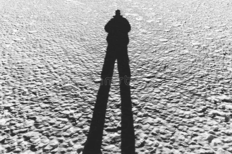 Man casting a long shadow stock photo. Image of body - 61197276