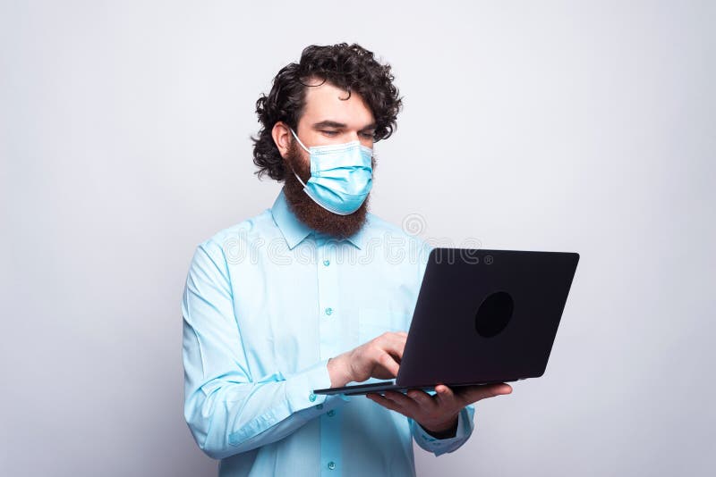 Man in Casual Wearing Medicinal Mask and Using Laptop Stock Image ...