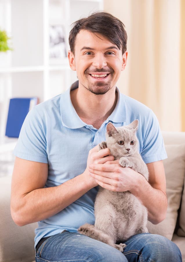 Man with cat stock photo. Image of home, blond, cheerful - 49688482