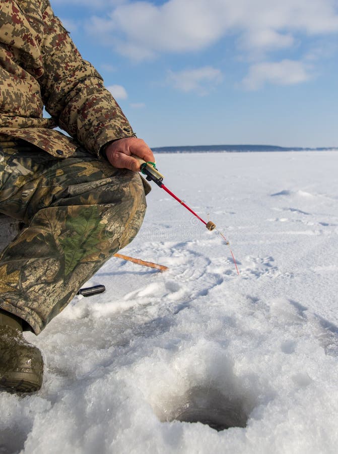 Man Catches Fish on Ice in Winter Stock Photo - Image of river, winter ...