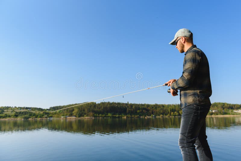 A Man Catches a Fish on a Spinning Fishing in the Summer Stock Photo ...