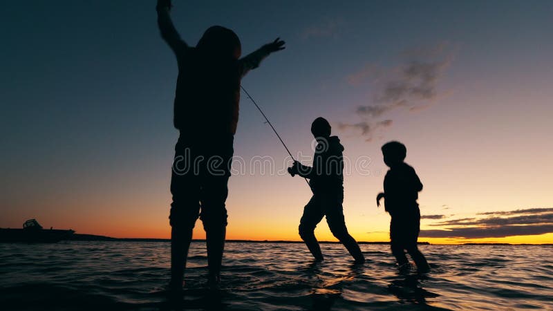 A Man is Catching Fish and His Kids are Having Fun Stock Video - Video ...