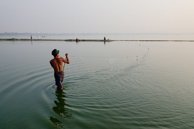 A Man Catching Fish on the Lake in Mandalay, Myanmar Editorial Stock ...