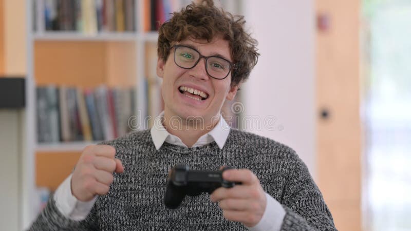 Young Man Celebrating Win while Playing Video Game Stock Image - Image ...