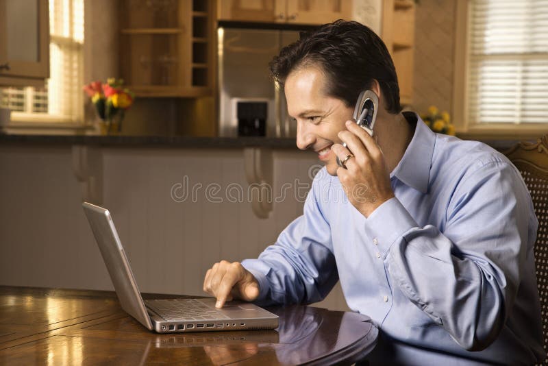 Man on Cell Phone and Laptop Stock Photo - Image of cell, inside: 12543576