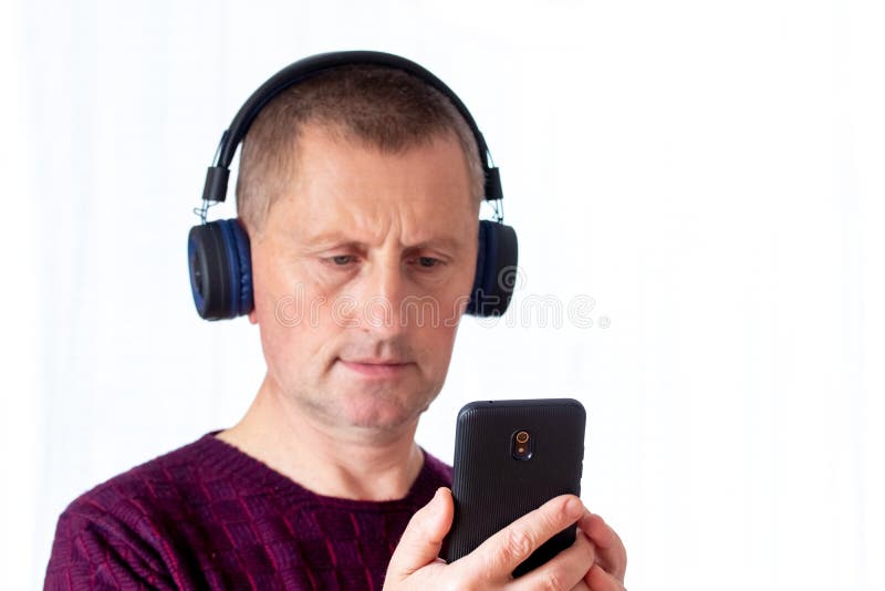 Man with Cell Phone and Wireless Headphones Stock Image - Image of ...