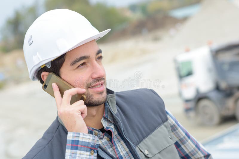 Man on Cellphone on Construction Site Stock Photo - Image of cellphone ...