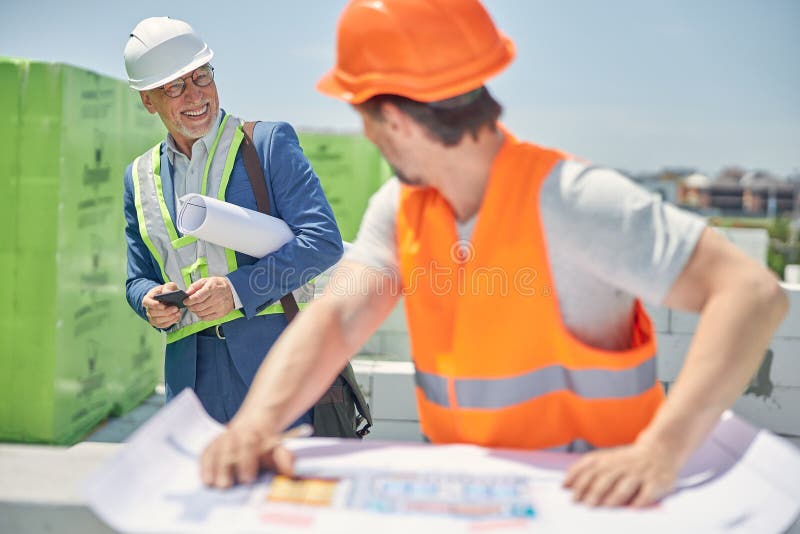 Construction Worker Standing in Front of the Table Outdoors Stock Image ...