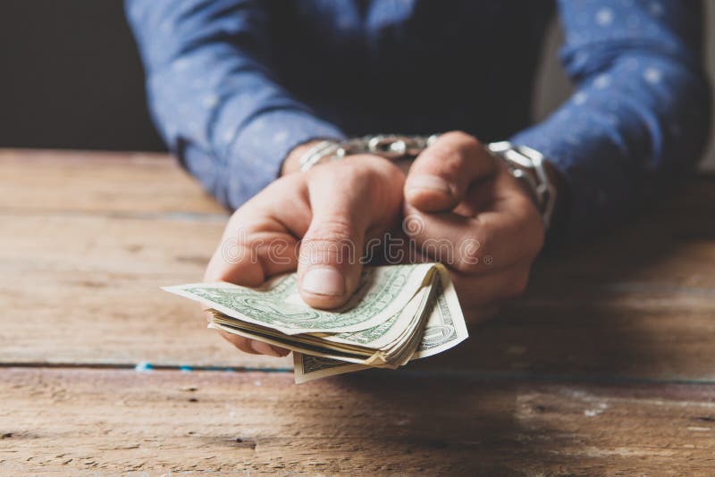 A Man in Chains Holds Money. Court Corruption Concept Stock Image ...