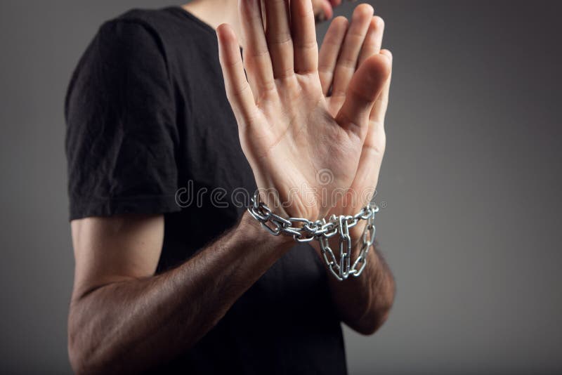 Man in chains shows stop stock photo. Image of chains - 226352980