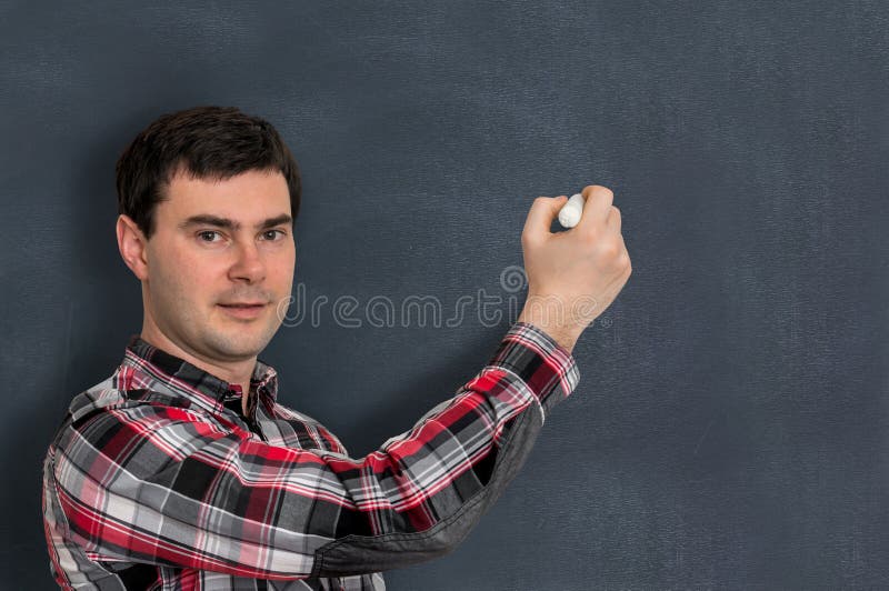 Man with Chalk is Writing on Blackboard Stock Photo - Image of ...