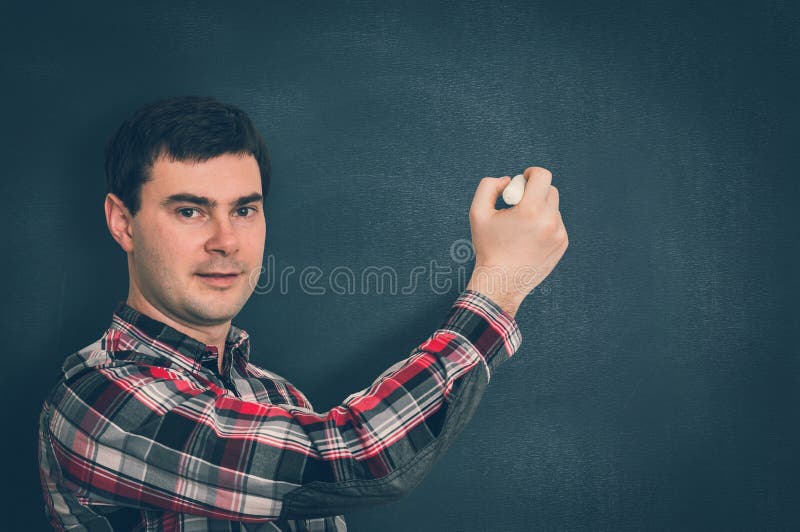 Man with Chalk is Writing on Blackboard - Retro Style Stock Photo ...