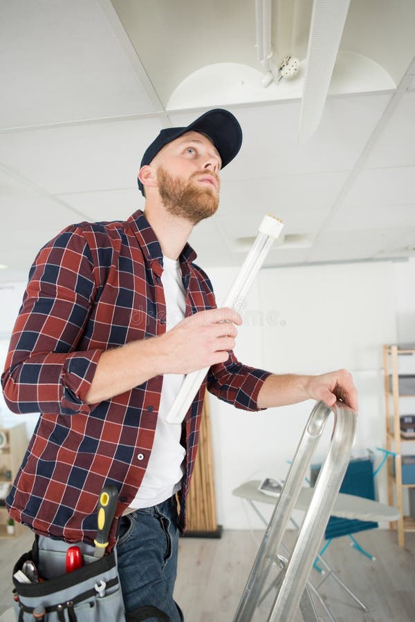 Man change neon light bulb stock image. Image of electrical - 288156071