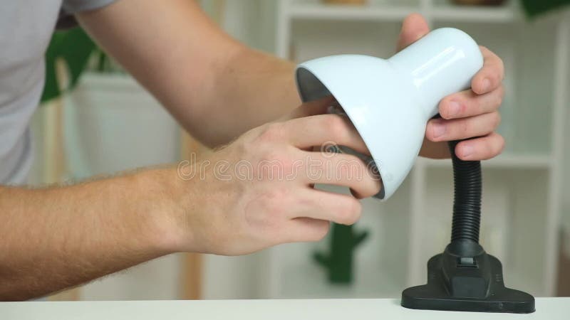 A Man Changes an Electric Lamp. Warm Yellow Light. Replacement an ...