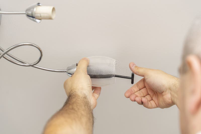 Man Changes a Light Bulb in a Lighting Device Stock Photo - Image of ...