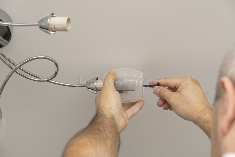 Man Changes a Light Bulb in a Lighting Device Stock Photo - Image of ...