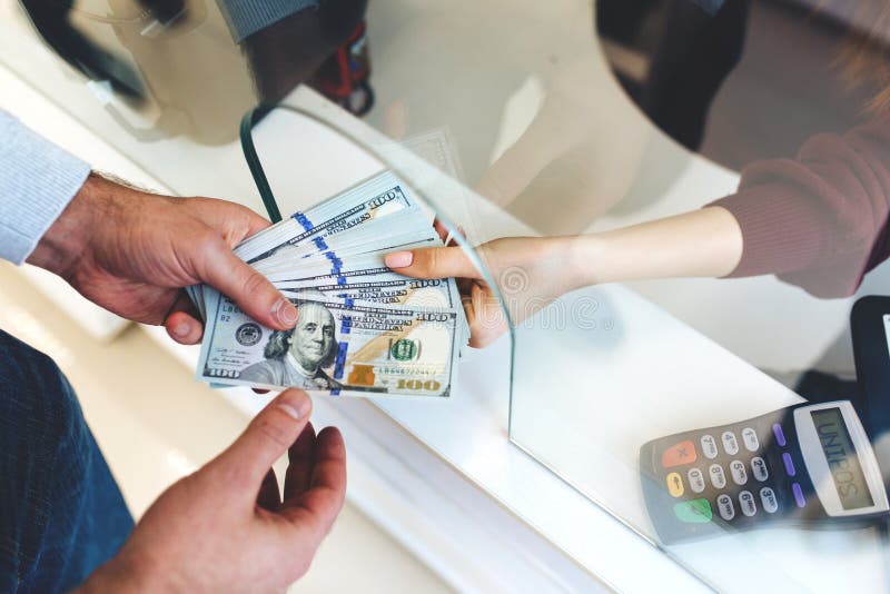 Man Changes Money in a Currency Exchange, a Large Sum of Dollars, an ...