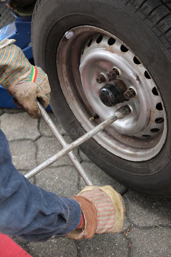 Man changing a car tyre stock photo. Image of automotive - 40268348