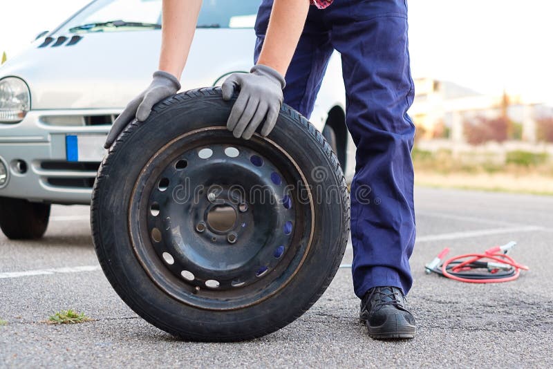 Man Changing a Flat Tyre after Vehicle Breakdown Stock Image - Image of ...