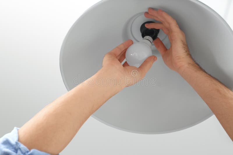 Man Changing Light Bulb in Lamp Indoors Stock Image - Image of domestic ...