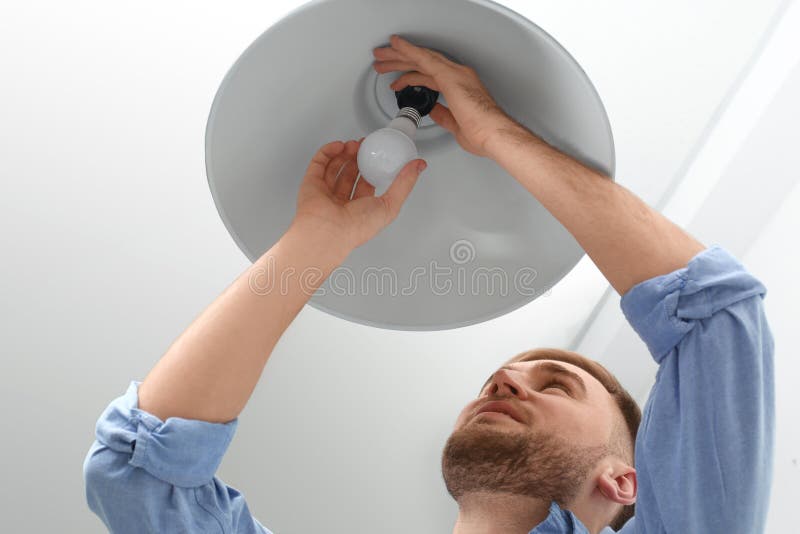 Man Changing Light Bulb in Lamp Stock Photo - Image of efficiency ...