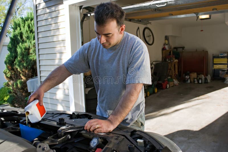Man Changing the Oil stock image. Image of preventative - 15186617