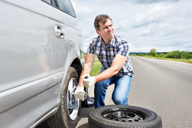 Man Changing a Spare Tire of Car Stock Image - Image of auto, strong ...