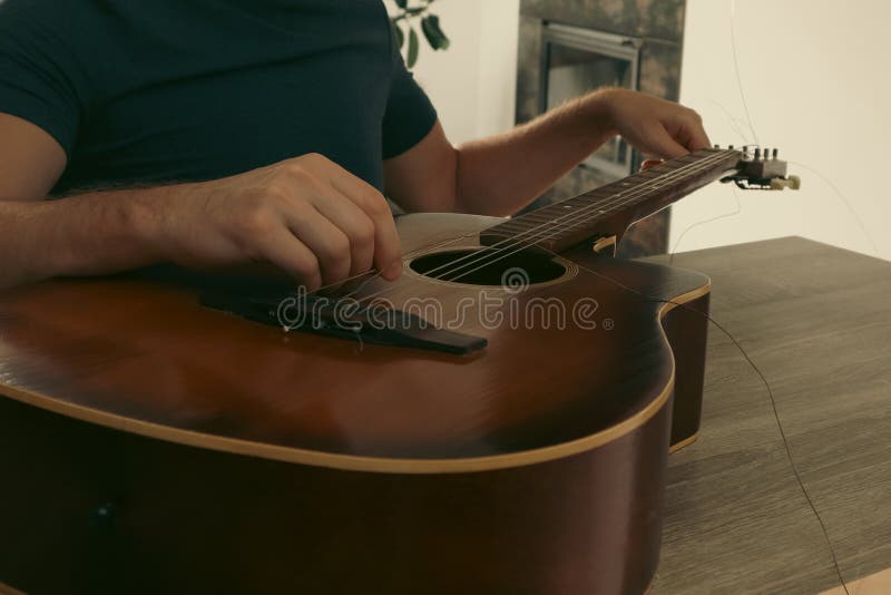 Man Changing the Strings of a Guitar at Home. Man S Hand are Installing ...