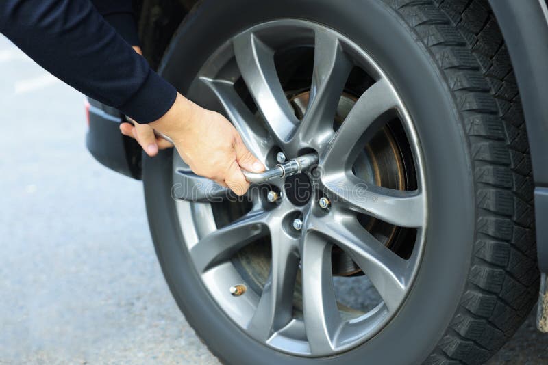 Man Changing Car Tire Near Road, Focus on Emergency Warning Triangle ...