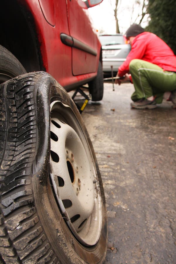Man Changing a Tire on the Street Stock Image - Image of fixing ...