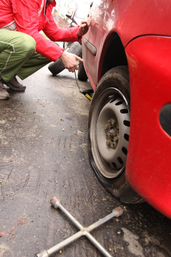 Man Changing a Tire on the Street Stock Photo - Image of person ...