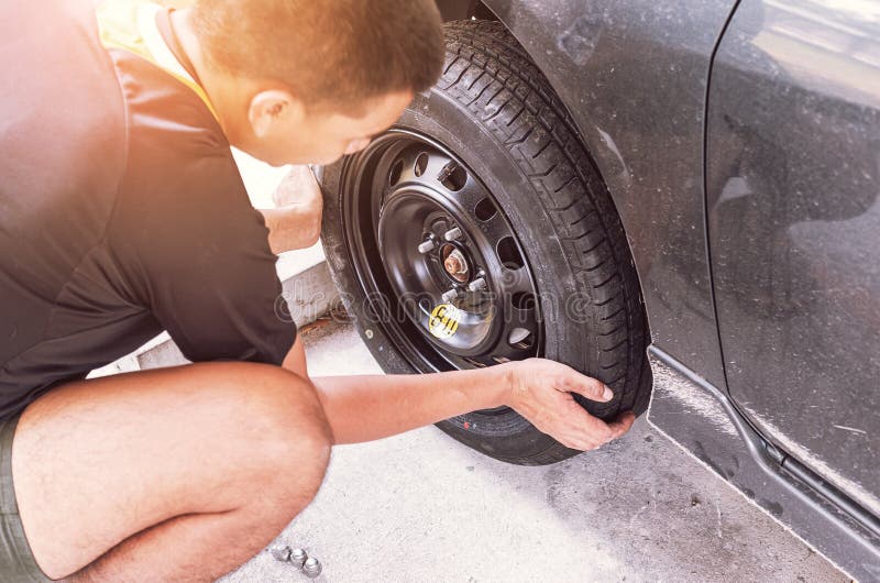 Man Changing Tire with Wheel Wrench Stock Photo - Image of driver ...