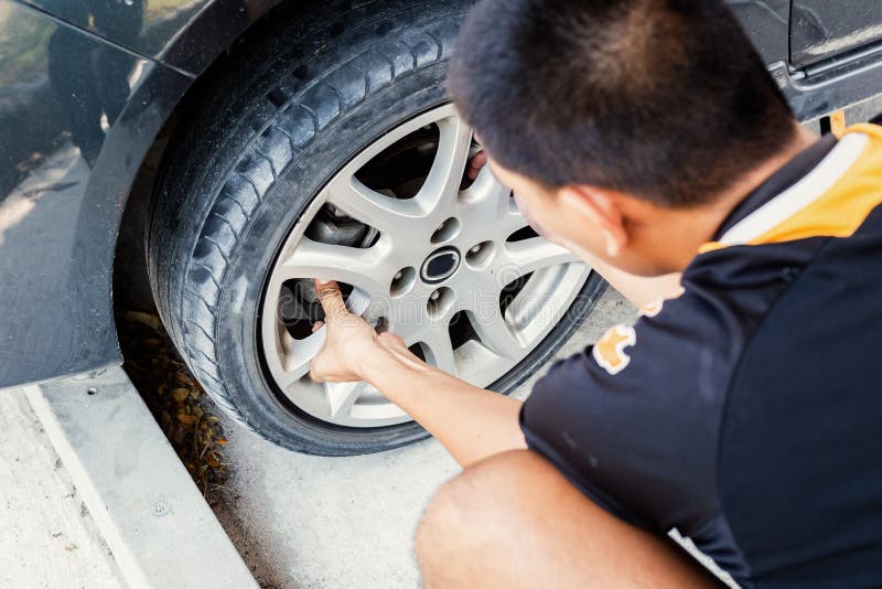 Man Changing Tire with Wheel Wrench in the Park Stock Image - Image of ...