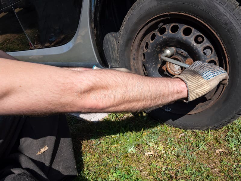 Man Changing Tires in Spring Stock Image - Image of bolts, tires: 195301185