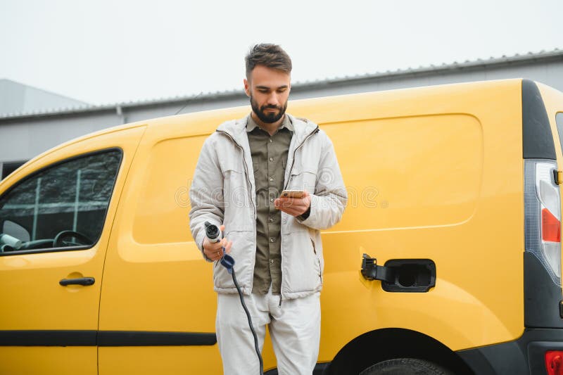 Man Charging Electric Car by the House Stock Photo - Image of auto ...