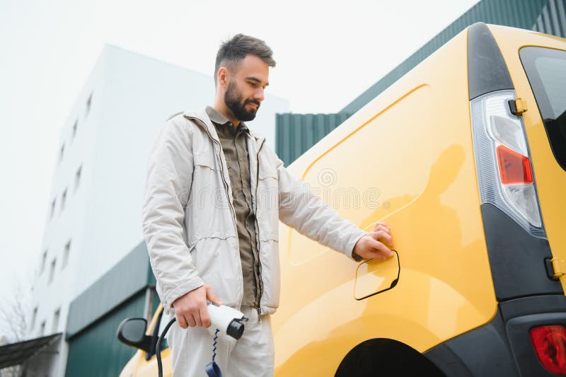 Man Charging Electric Car by the House Stock Photo - Image of male ...