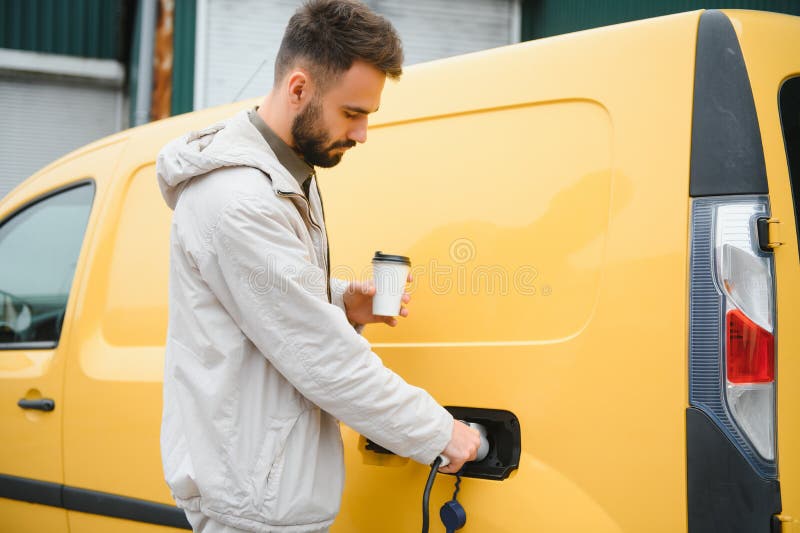 Man Charging Electric Car by the Work Stock Image - Image of energy ...
