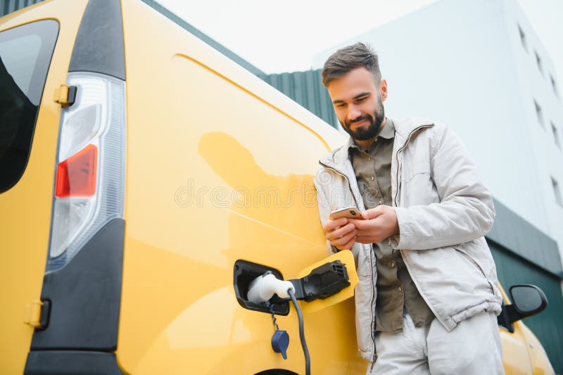Man Charging Electric Car by the Work Stock Photo - Image of charger ...