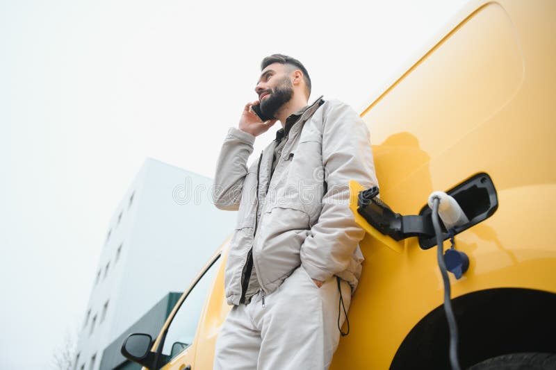 Man Charging Electric Car by the Work Stock Image - Image of charge ...